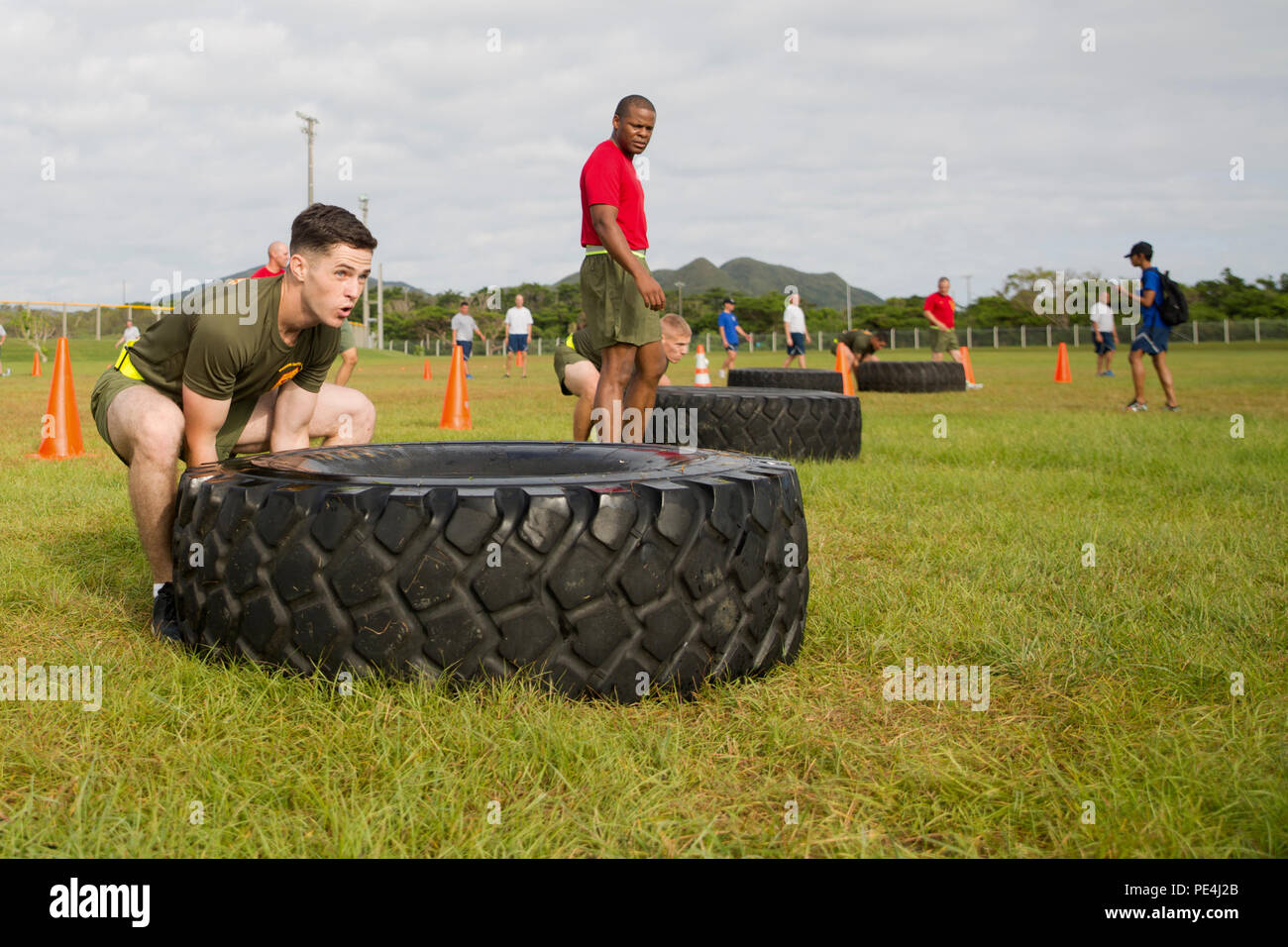 Sgt. Ralph I. Hotton prepares to start the tire flip portion of a relay ...