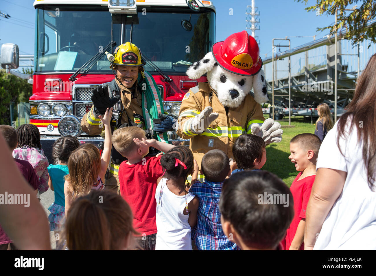 Students with Matthew C. Perry Elementary School gather around to greet ...