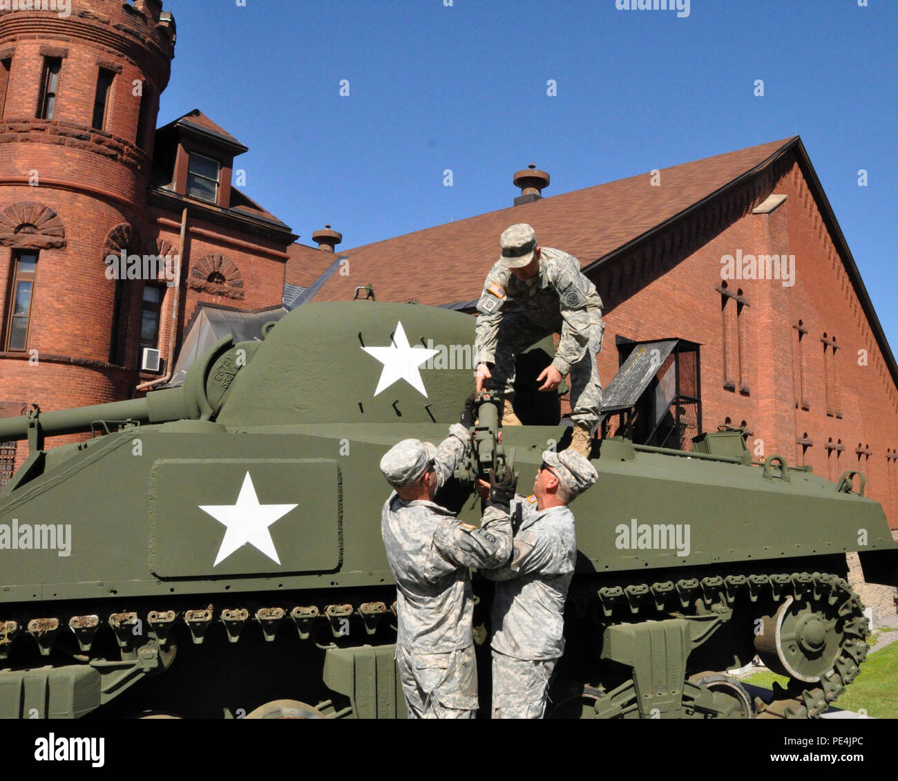 New York Army National Guard Spc. Cory Peck, (left) assigned to the ...