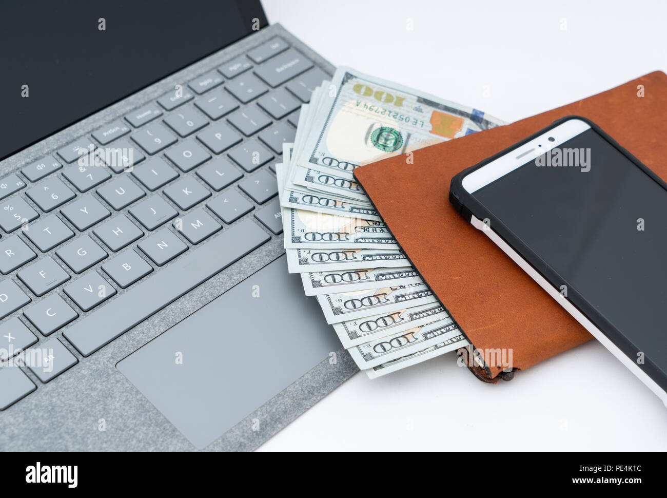 Laptop computer isolated ,money, cellphone Stock Photo - Alamy