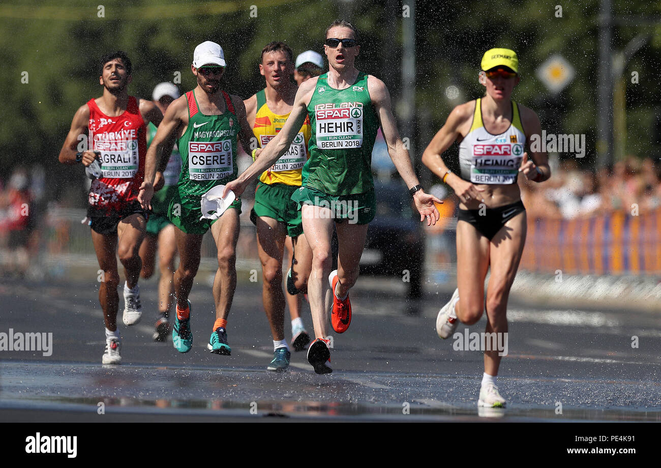 Ireland's Sean Hehir runs through a water sprinkler as he takes part in ...