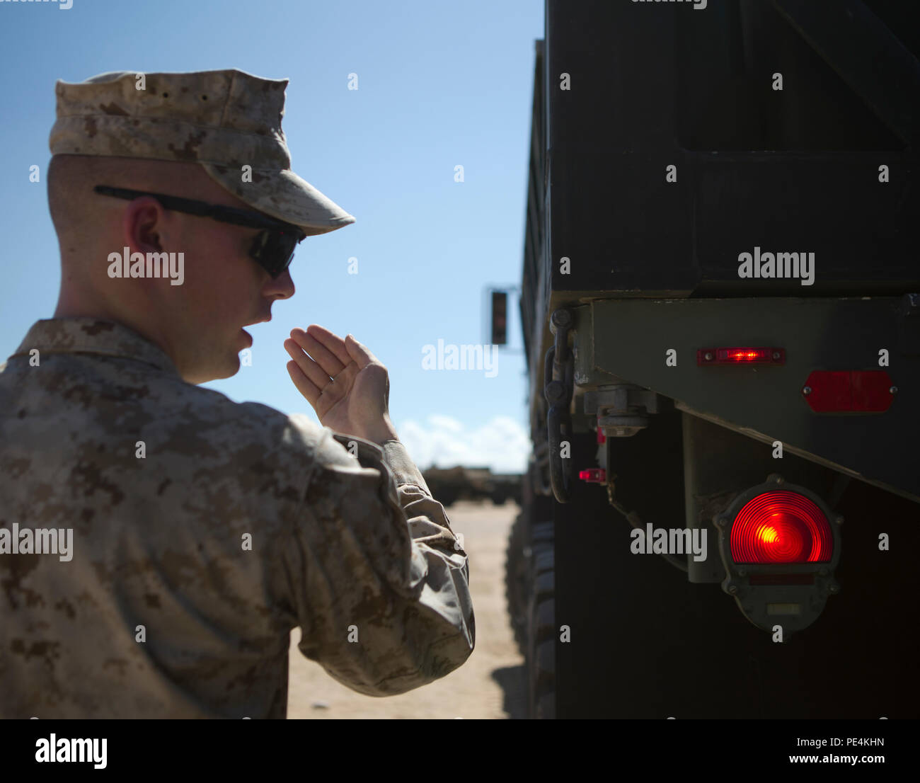 U.S. Marine Corps Lance Cpl. Stenger, Evan, a radar technician, signals ...