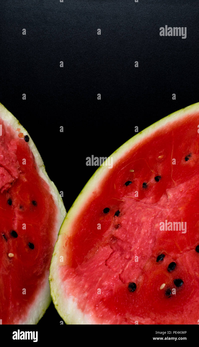 delicious watermelon cut in halves isolated on black background with ...