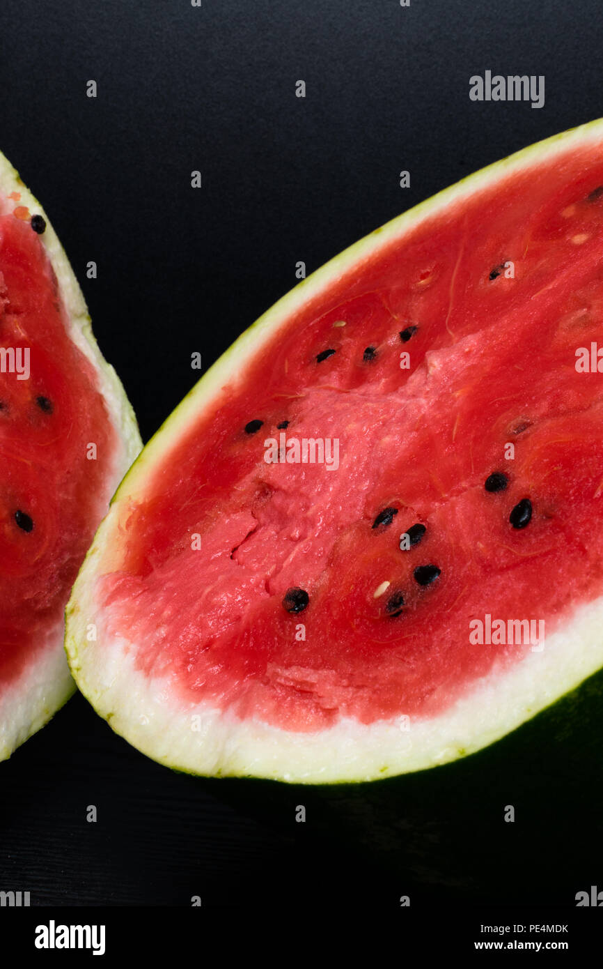 delicious watermelon cut in halves isolated on black background with ...