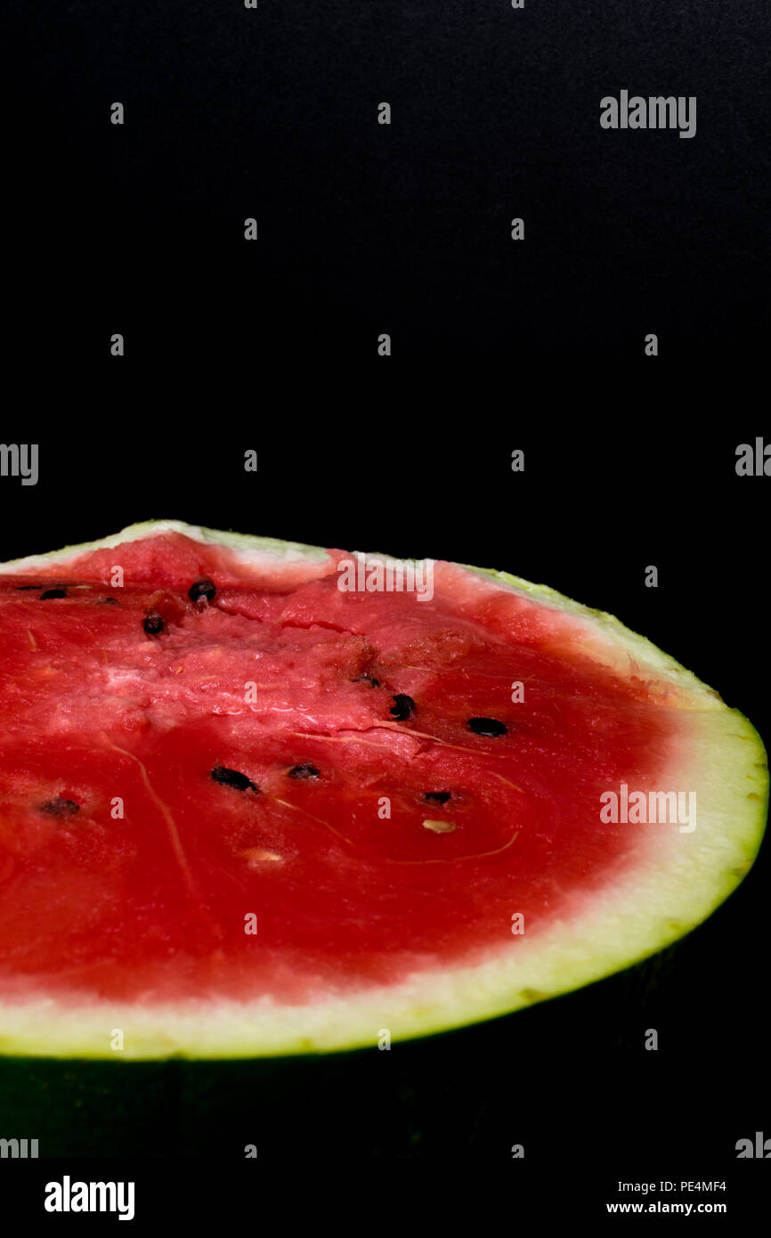delicious watermelon cut in halves isolated on black background with ...