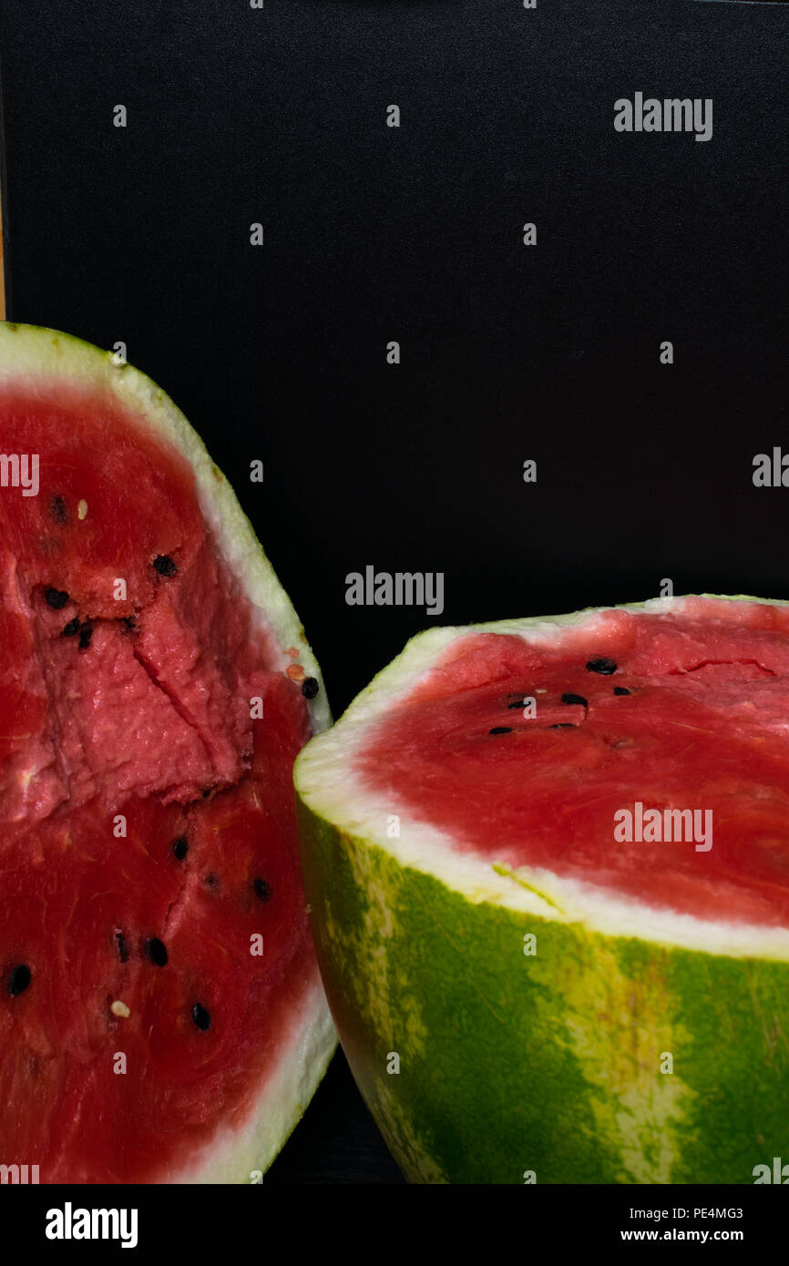 delicious watermelon cut in halves isolated on black background with ...