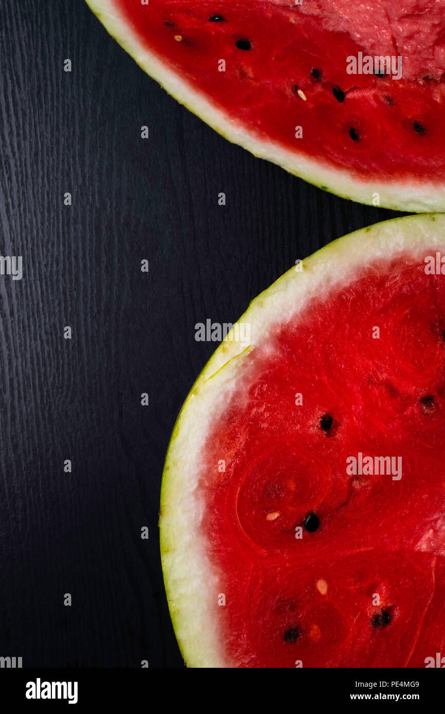 delicious watermelon cut in halves isolated on black background with ...