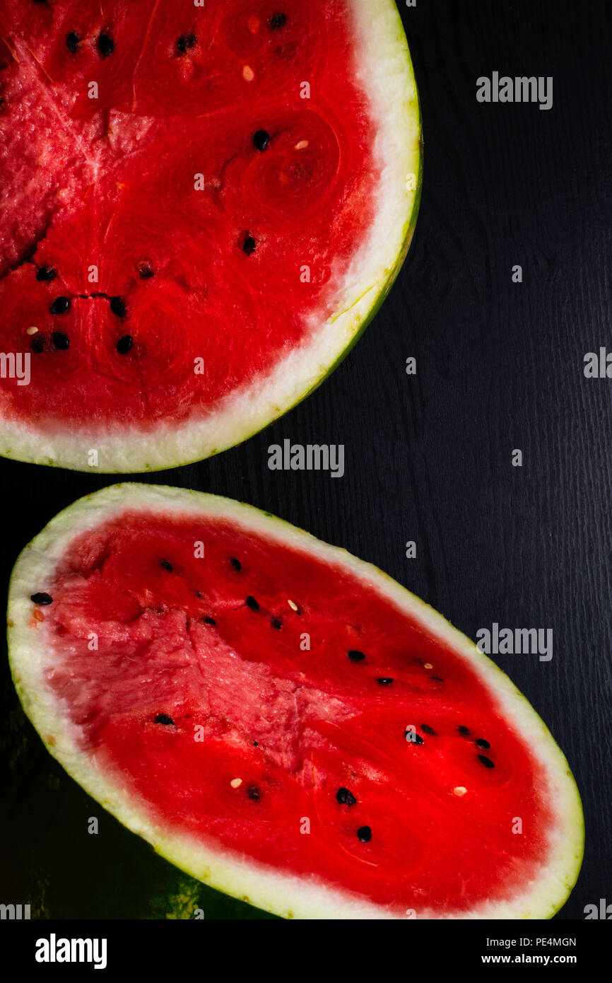 delicious watermelon cut in halves isolated on black background with ...