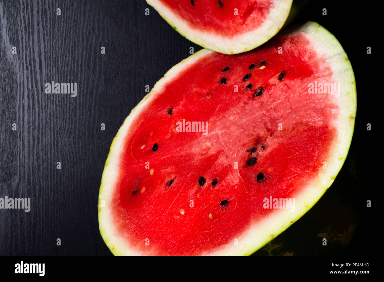 delicious watermelon cut in halves isolated on black background with ...