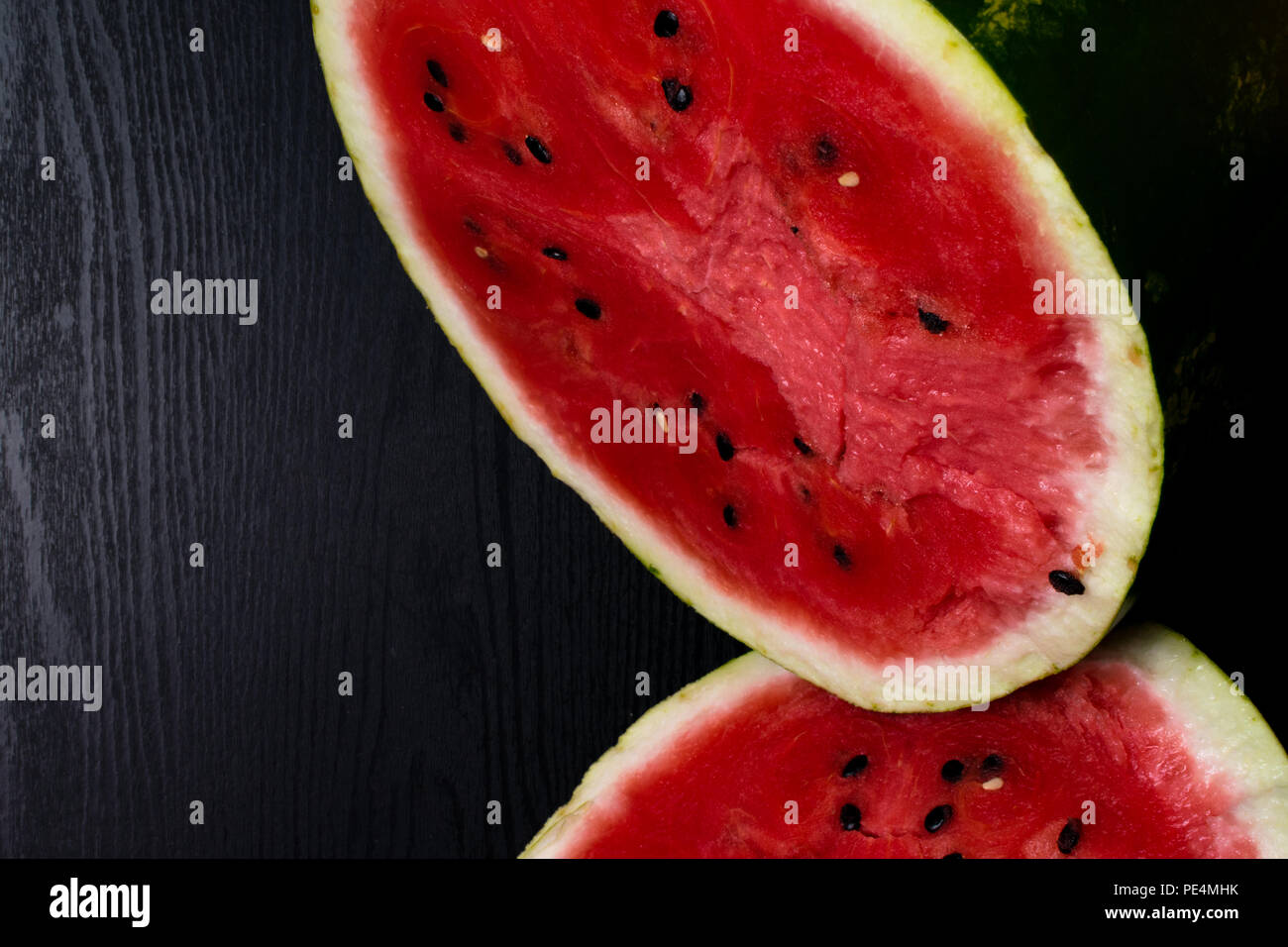 delicious watermelon cut in halves isolated on black background with ...