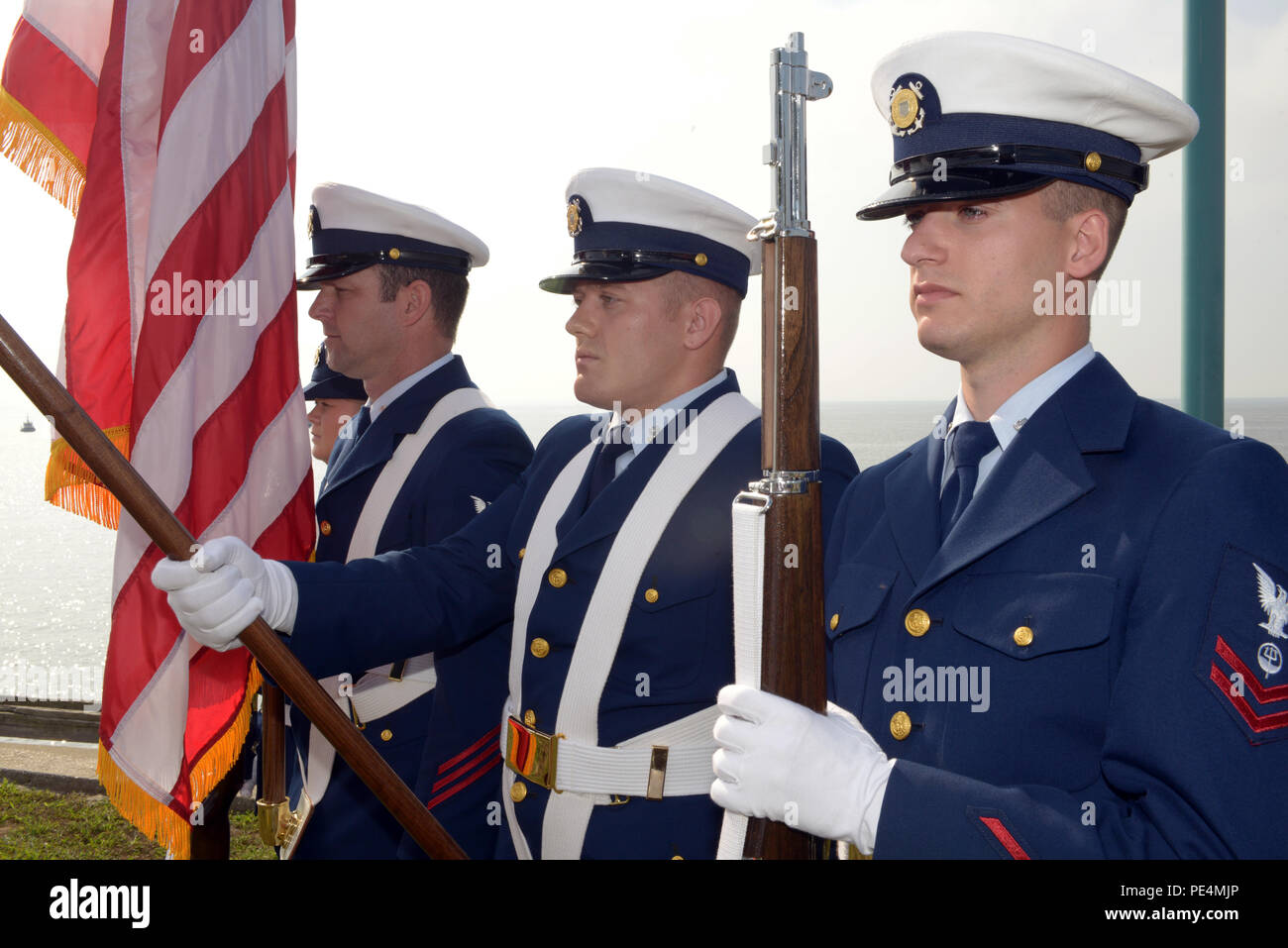 Coast Guard color guard service members present flags during the ...