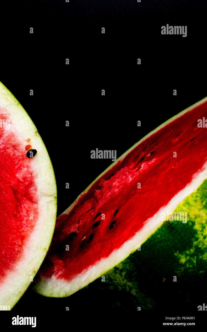 delicious watermelon cut in halves isolated on black background with ...