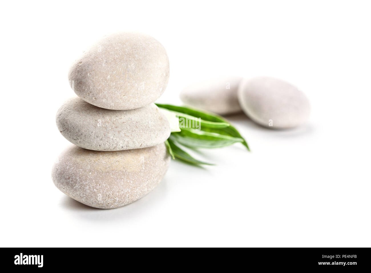 stones and green leaves isolated on white background Stock Photo - Alamy