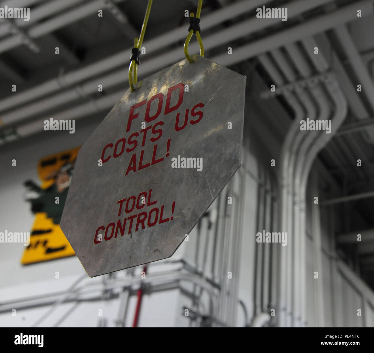 A sign hangs from the ceiling in the structural maintenance shop at ...