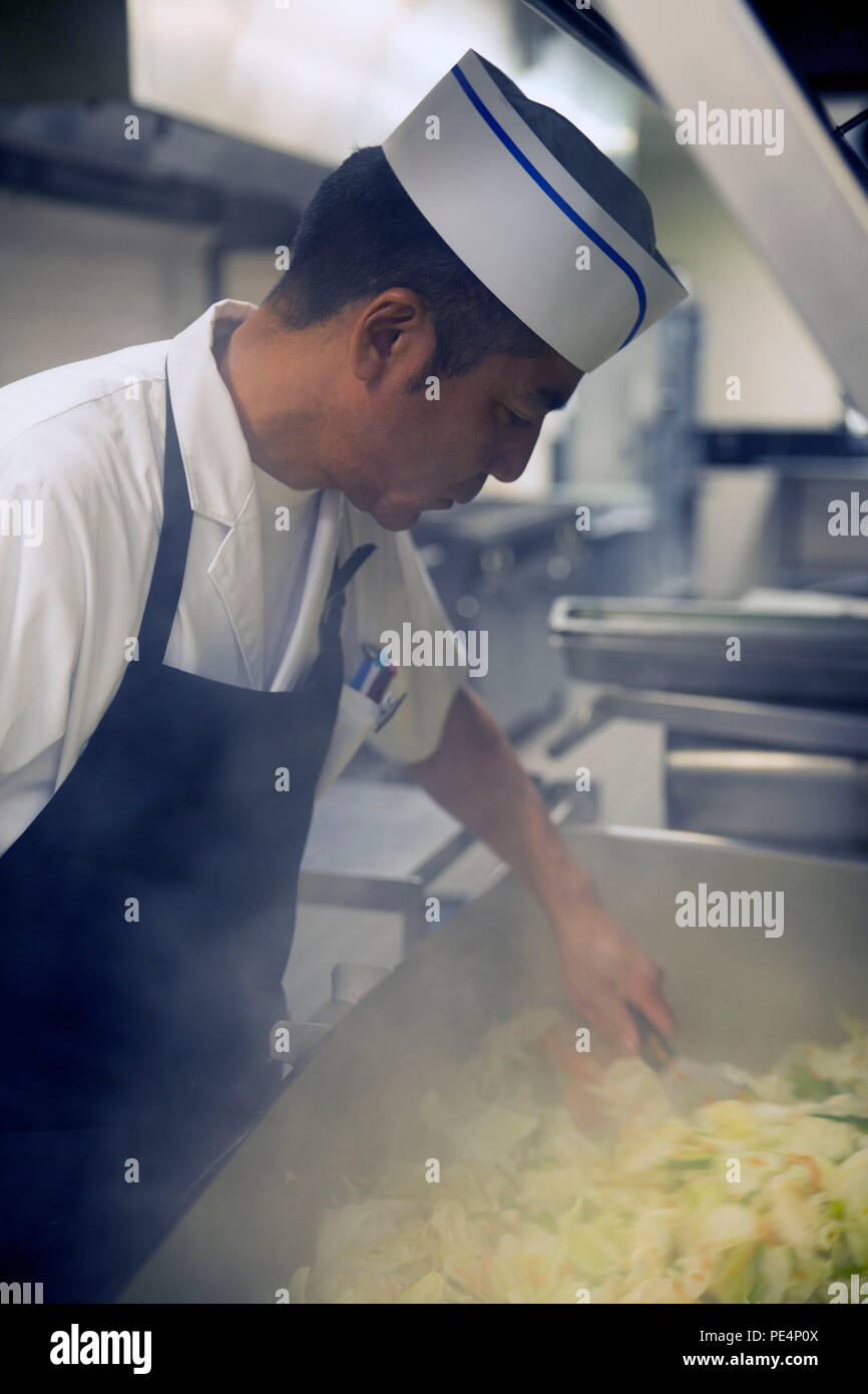 Tomohito Shimada, a chief cook, cooks stir fry in the 12th Marines Mess ...