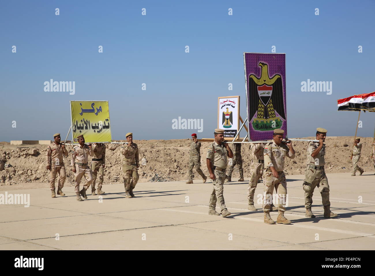 Members of the Popular Mobilization Program parade their unit emblems ...