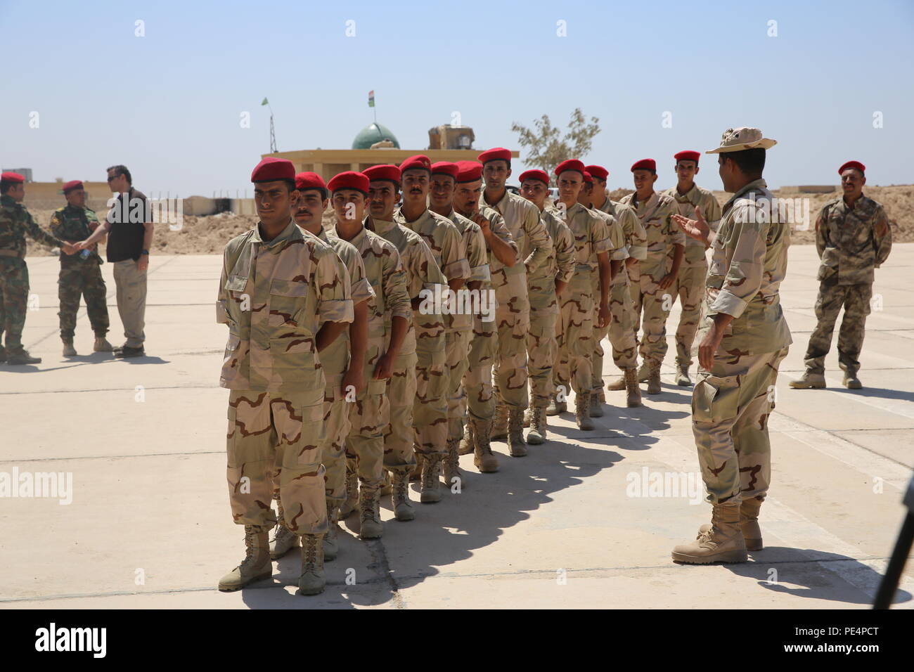 Members of the Popular Mobilization Program line up before their ...