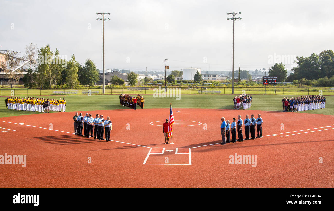 Active-duty military softball teams render honors to the American flag ...