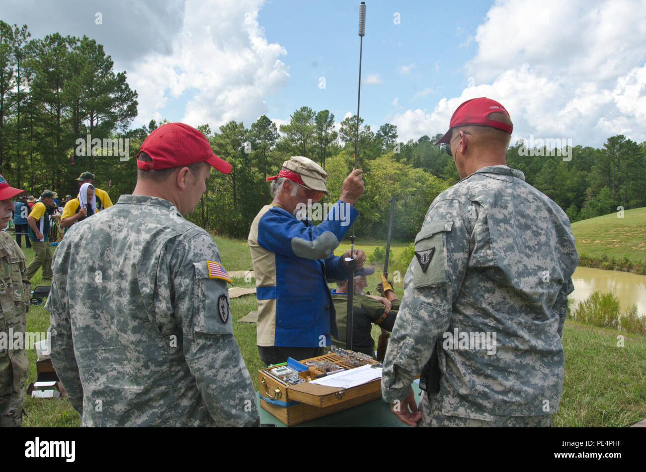 A member of team USA reloads his rifle as two North Carolina Army ...