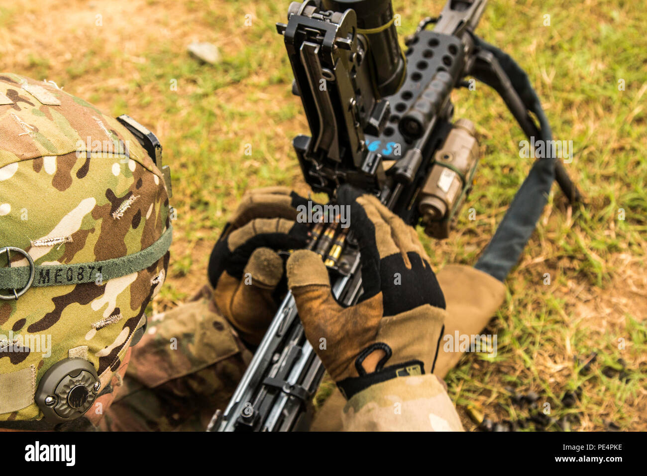 Sergeant Ben Mercer, a combat engineer, loads a 16-round link into his ...