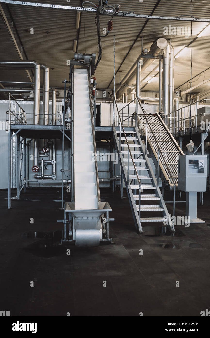 Industrial machinery interiors. Huge production hall of factory for ...