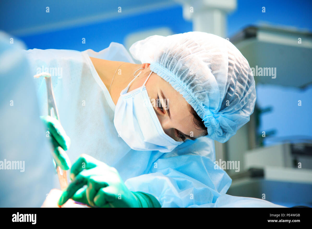 Surgeon operating a patient in operating room Stock Photo - Alamy
