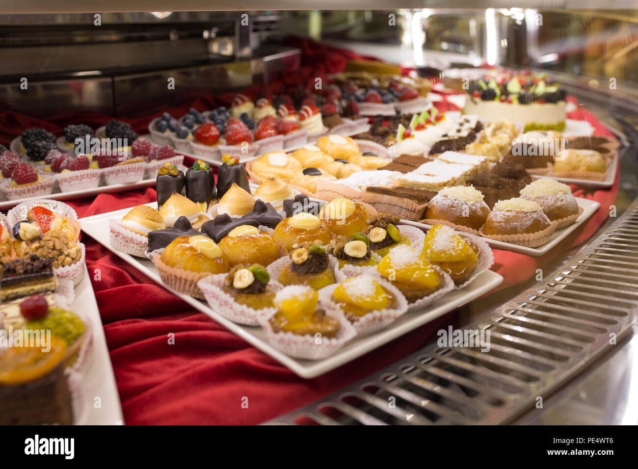 Different colorful Tasty beautiful cakes on a show-window in caf Stock ...