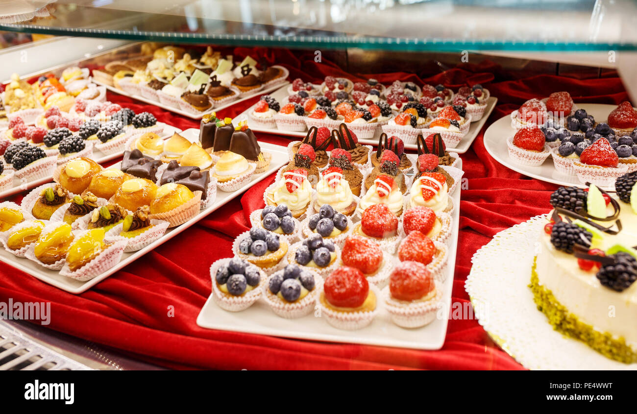 Different colorful Tasty beautiful cakes on a show-window in caf Stock ...