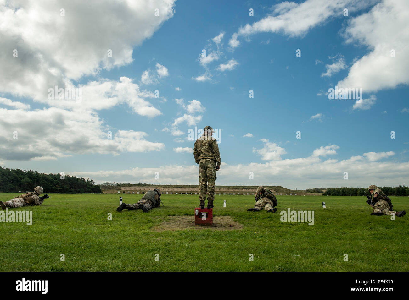 A member of British Royal Marines range personnel observes the firing ...