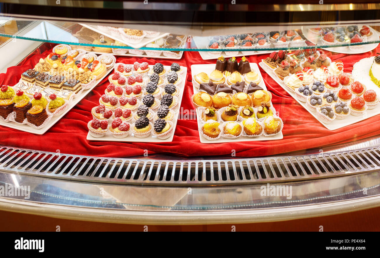 Different colorful Tasty beautiful cakes on a show-window in caf Stock ...