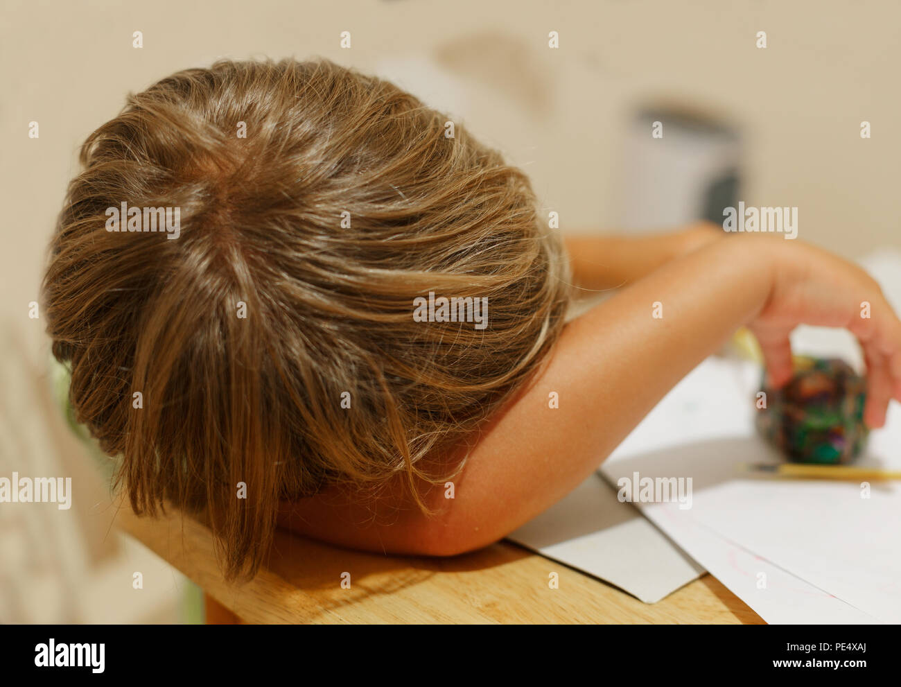 A little boy fell asleep at the table while playing Stock Photo - Alamy