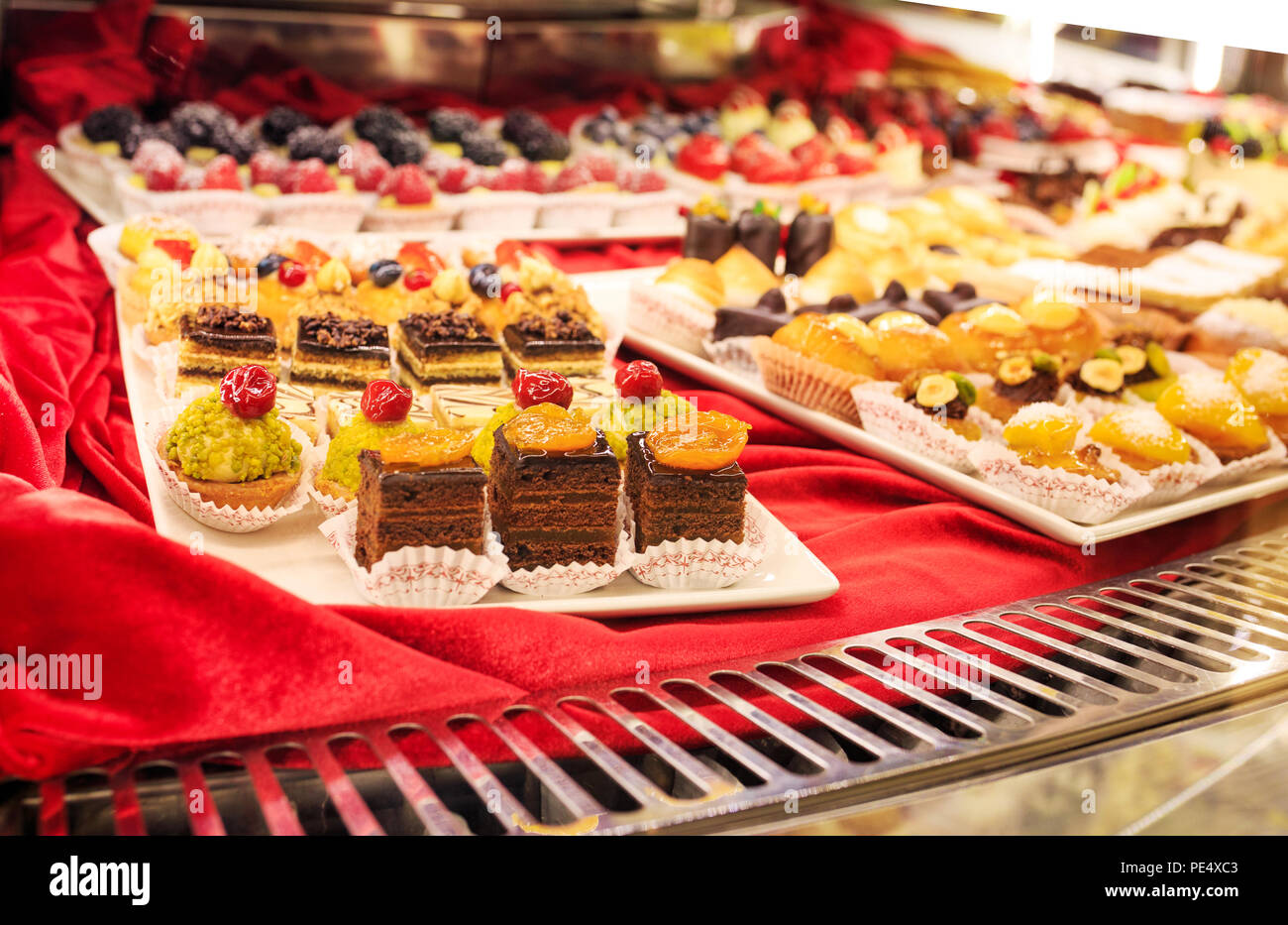 Different colorful Tasty beautiful cakes on a show-window in caf Stock ...