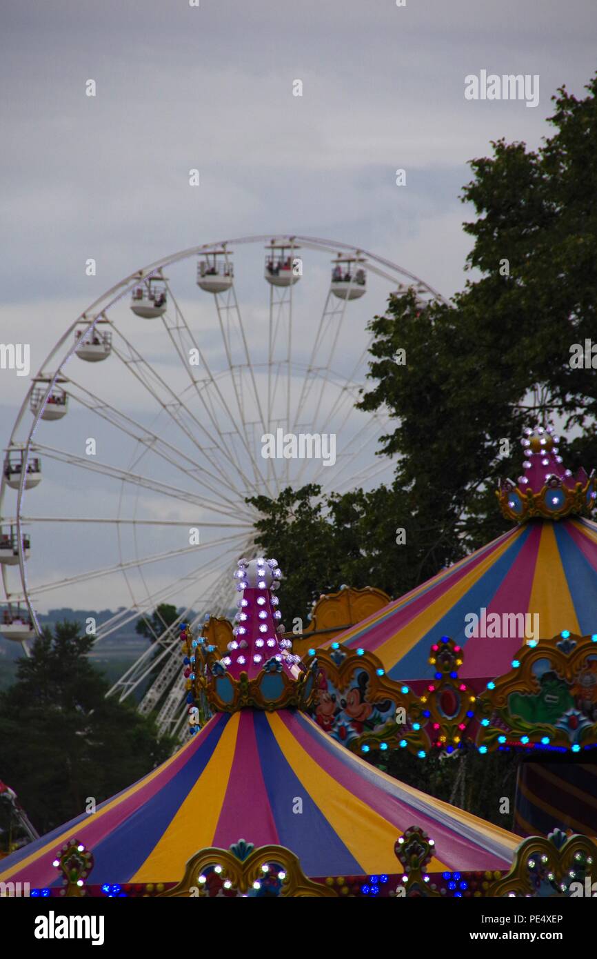 Ferris wheel beyond Carnival Rides at Ashton Court Estate, Bristol ...
