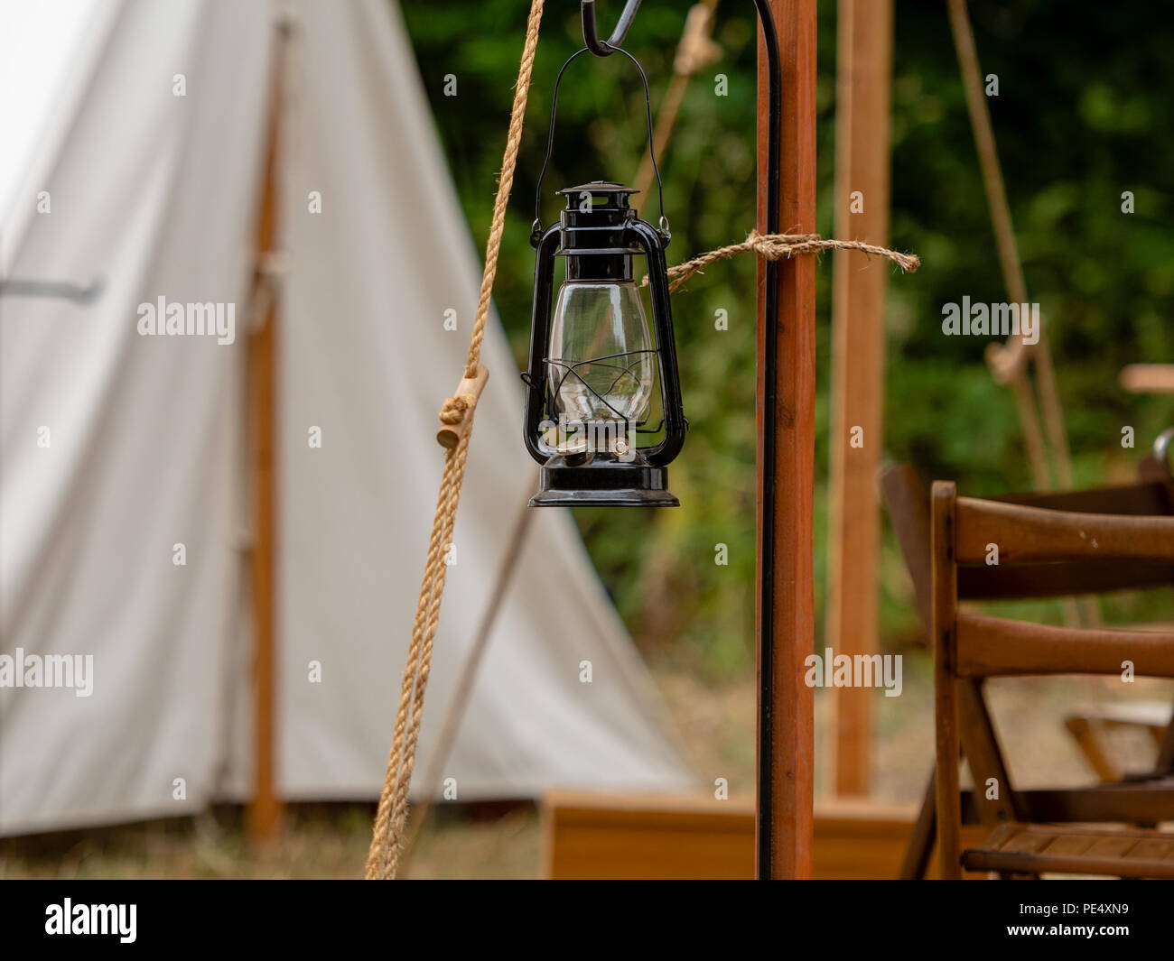 Old 1800s gas lantern hanging at the entrance of a canvas tent ...