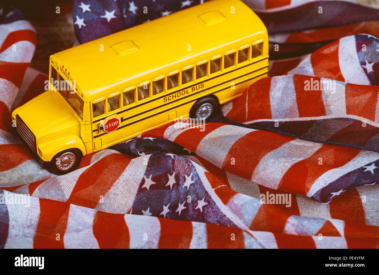 Small town school bus and american flag background Stock Photo - Alamy