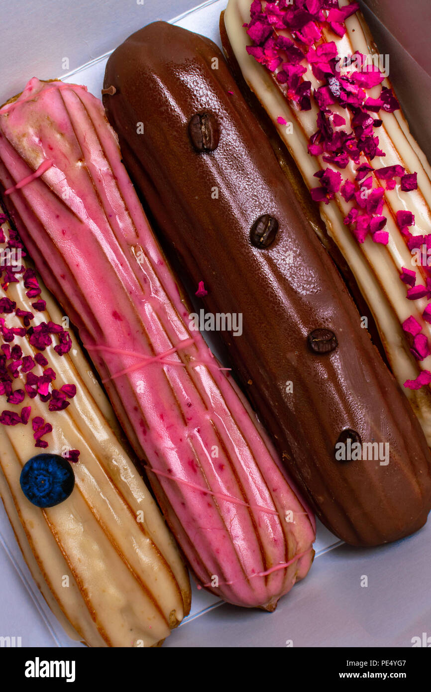 French traditional eclair, decorated with raspberry and cream Stock ...