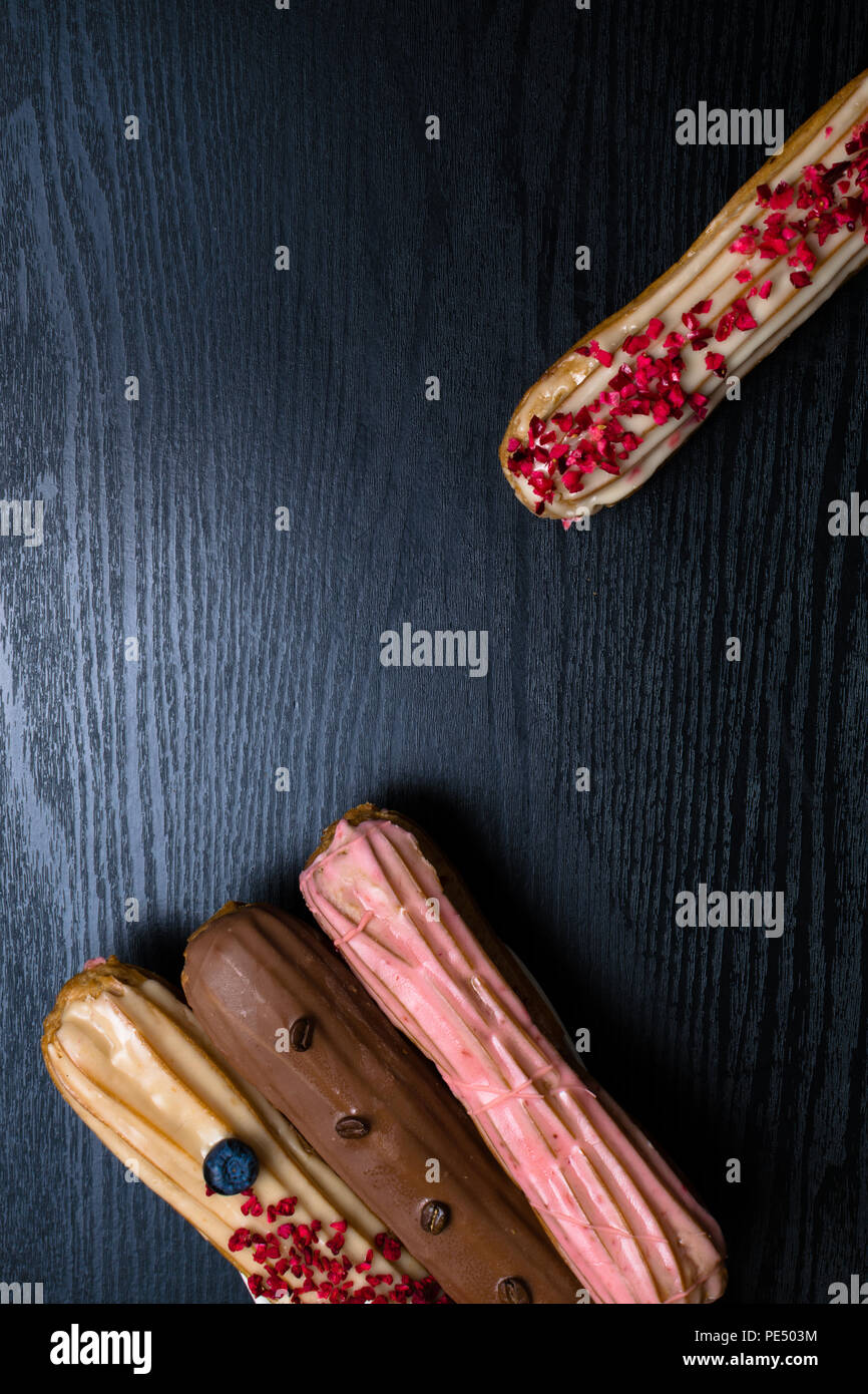 French traditional eclair, decorated with raspberry, blueberry,cream ...