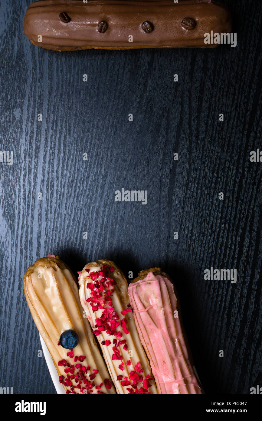 French traditional eclair, decorated with raspberry, blueberry,cream ...