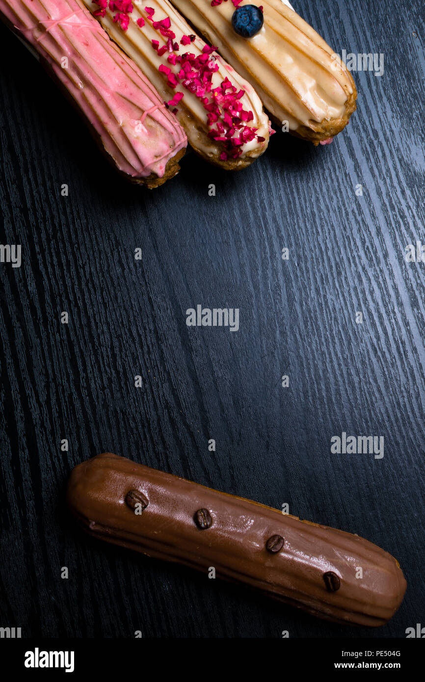 French traditional eclair, decorated with raspberry, blueberry,cream ...