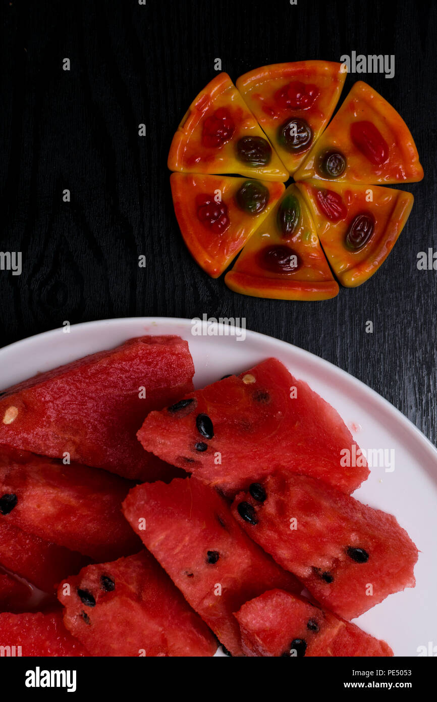 raw red watermelon and watermelon slices, fresh fruit and sweet candy ...