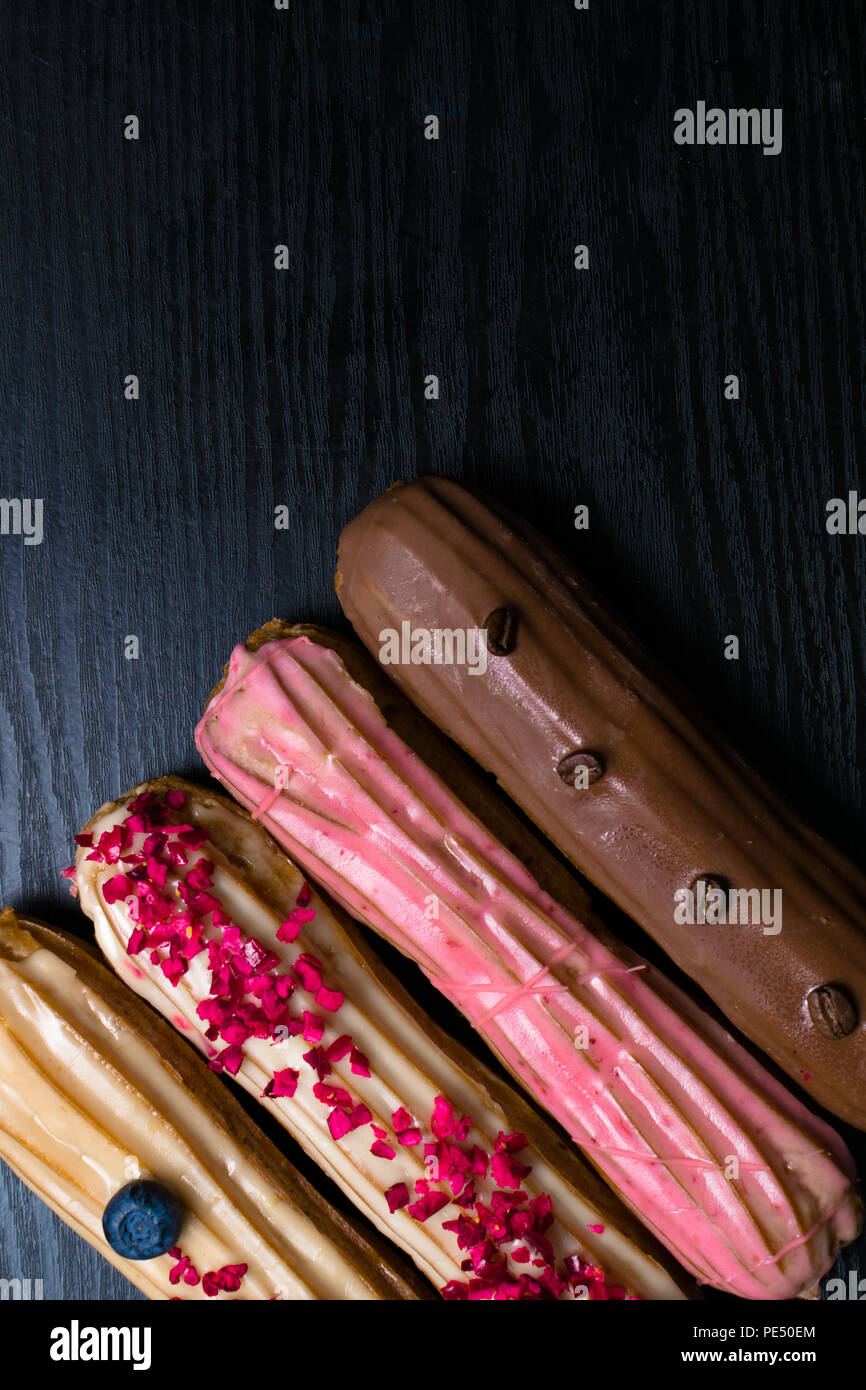French traditional eclair, decorated with raspberry, blueberry,cream ...
