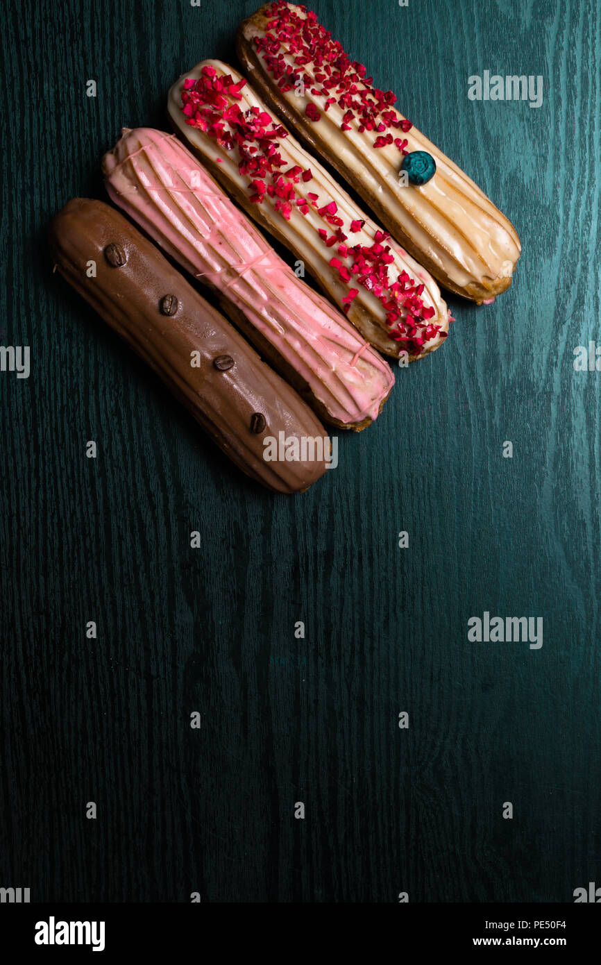 French traditional eclair, decorated with raspberry, blueberry,cream ...