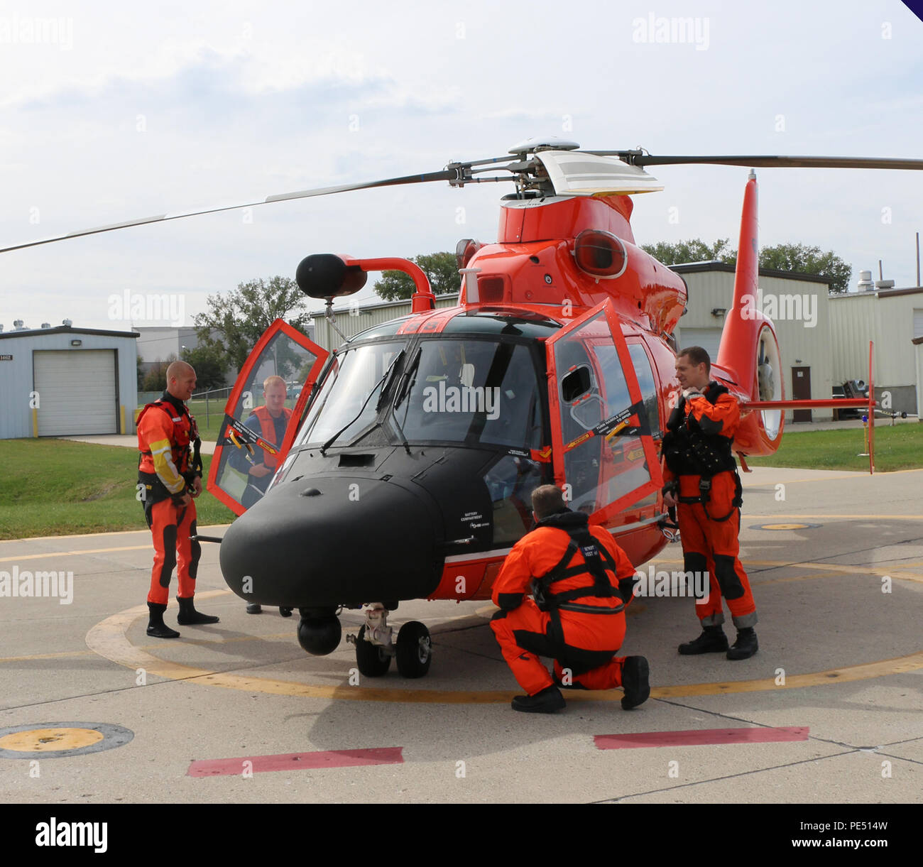 Members of Coast Guard Air Station Detroit inspect a rescue helicopter ...