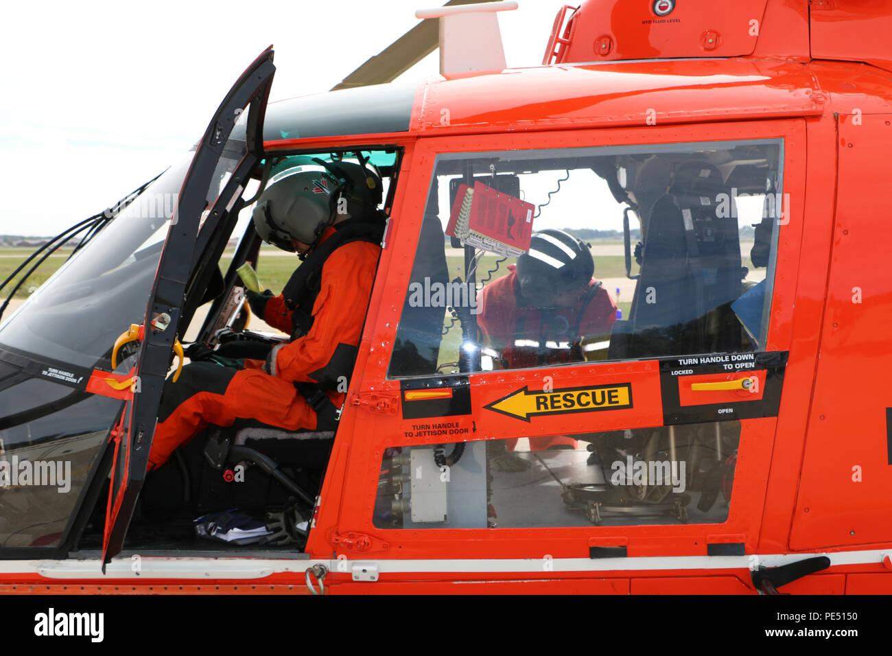Members of Coast Guard Air Station Detroit conduct a preflight check of ...