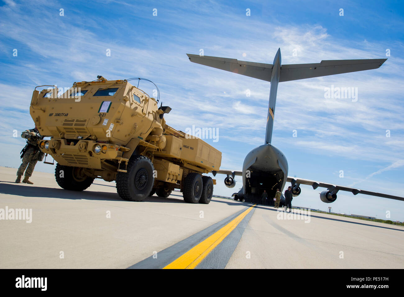 Army and Air Force crews prepare to load a High Mobility Artillery ...
