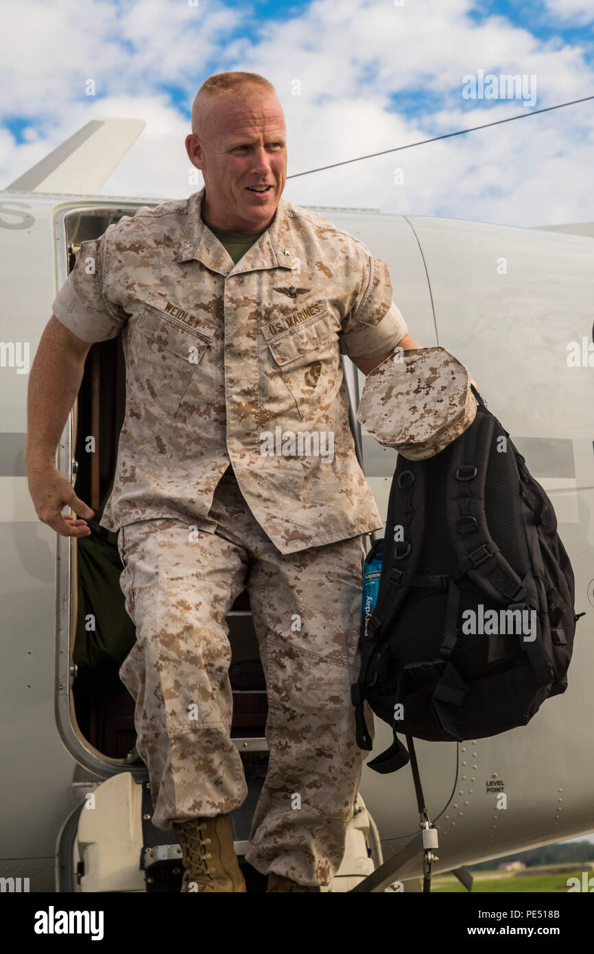 Brig. Gen. Thomas D. Weidley steps off of a C-12 Huron to begin his ...