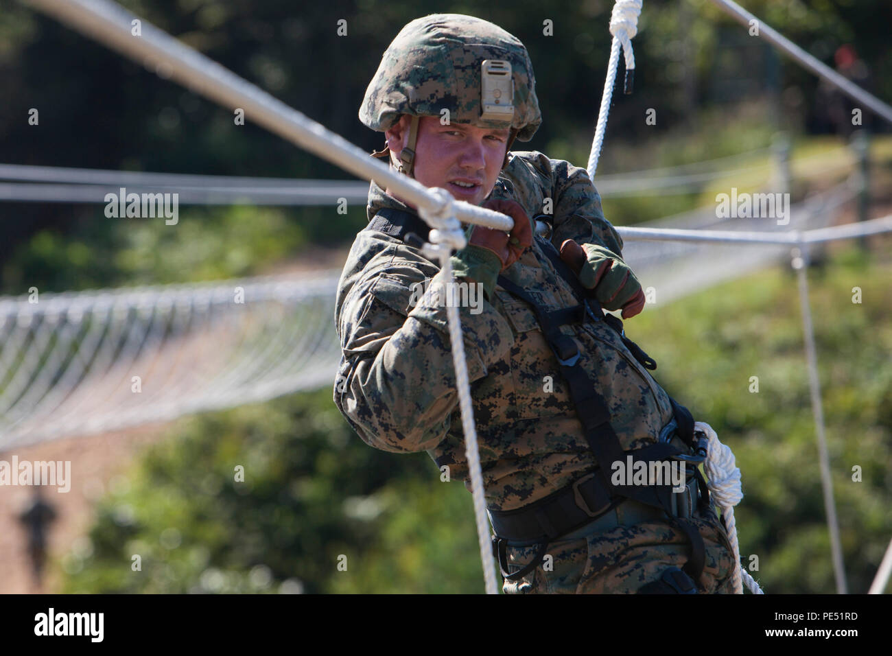 Lance Cpl. Robert A. Toussant crosses a two-rope bridge at ...