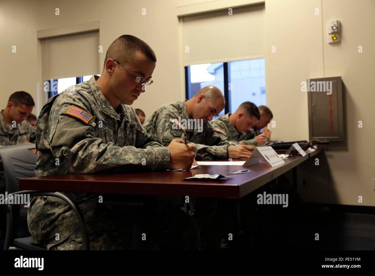 U.S. Soldiers complete a written exam for the U.S. Army Best Warrior ...