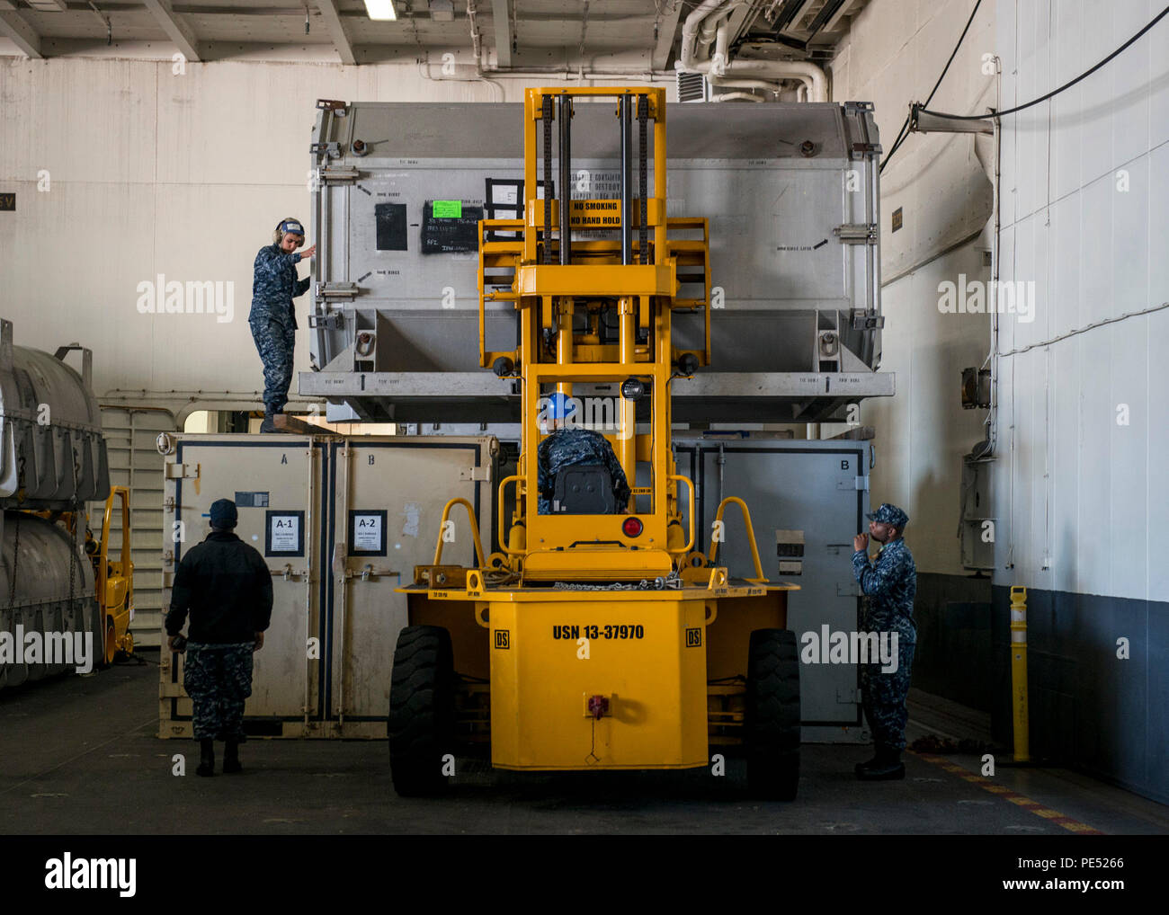 151007-N-IN729-015 YOKOSUKA, Japan (Oct. 7, 2015) Sailors move a jet ...