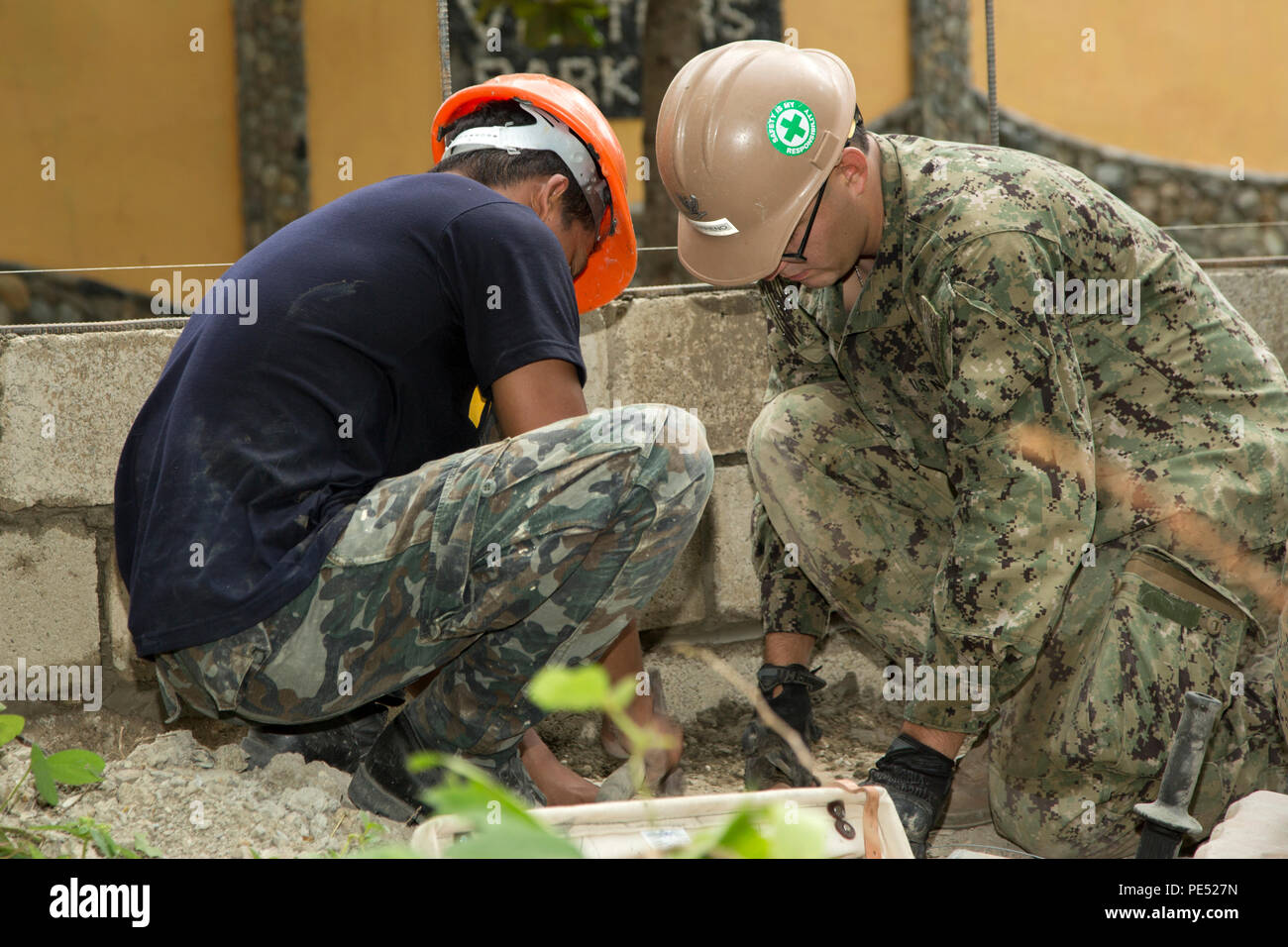 A Philippine sailor and U.S. Navy Seabee Petty Officer 3rd Class Anthony Carreno, steel worker ...